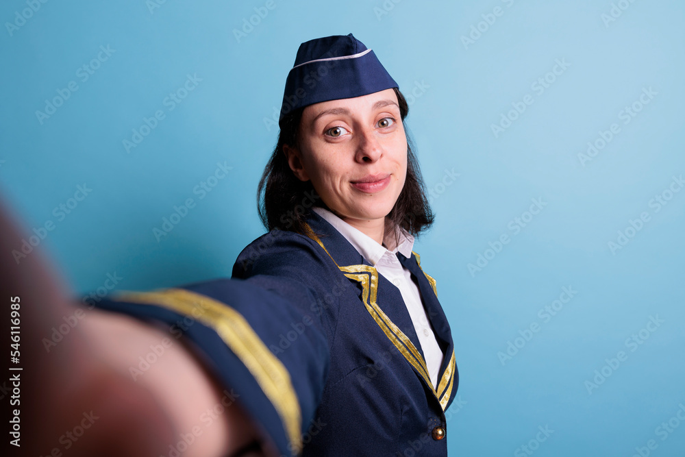 Smiling flight attendant taking selfie first person view, airplane ...