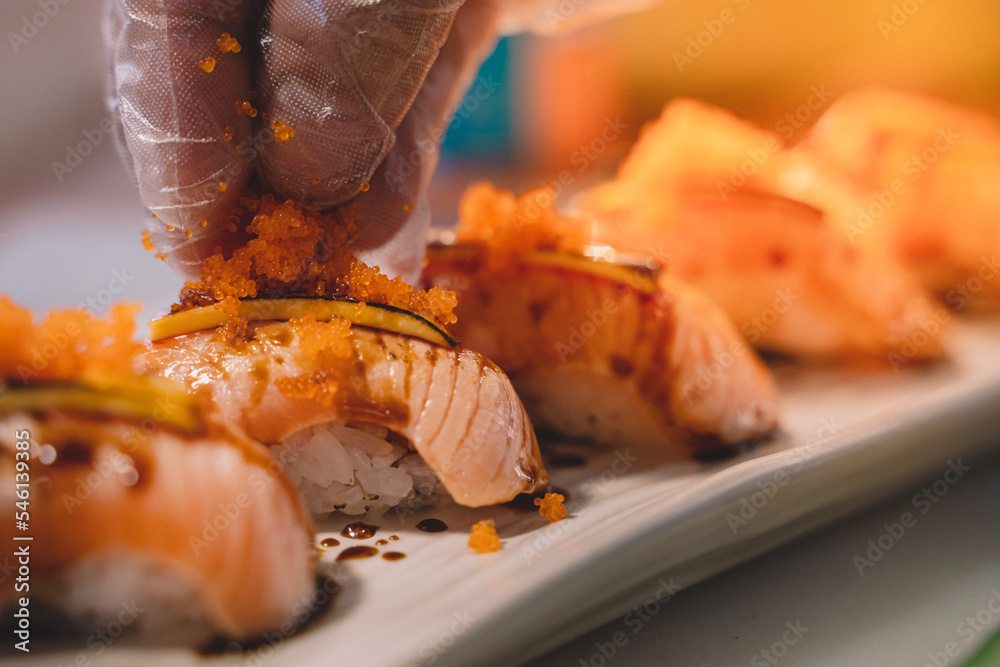 Chef is making sushi to serve customers. sushi is a street food of ...