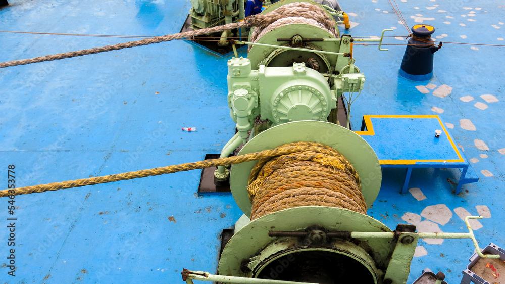 mooring rope and winch on the deck of a commercial ship. mechanical ...