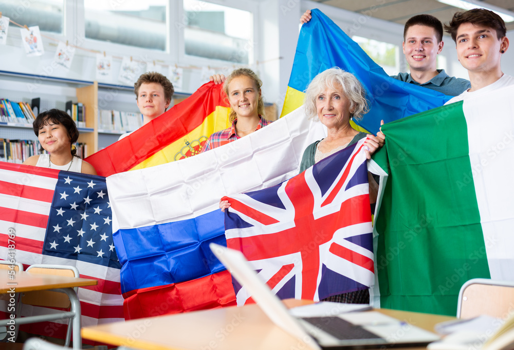 Portrait of a group of fifteen-year-old schoolchildren with a mature ...