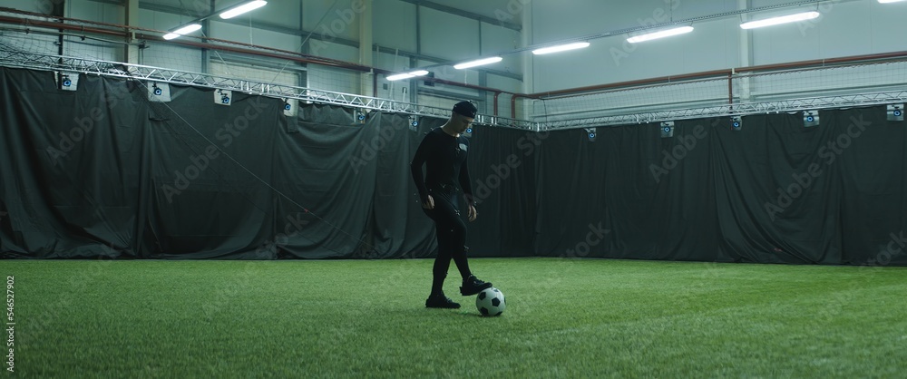 Soccer football player wearing motion capture suit performing kicks and ...