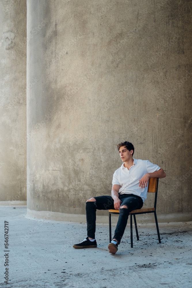 Cool Young Male Model Sitting on Chair Stock Photo | Adobe Stock