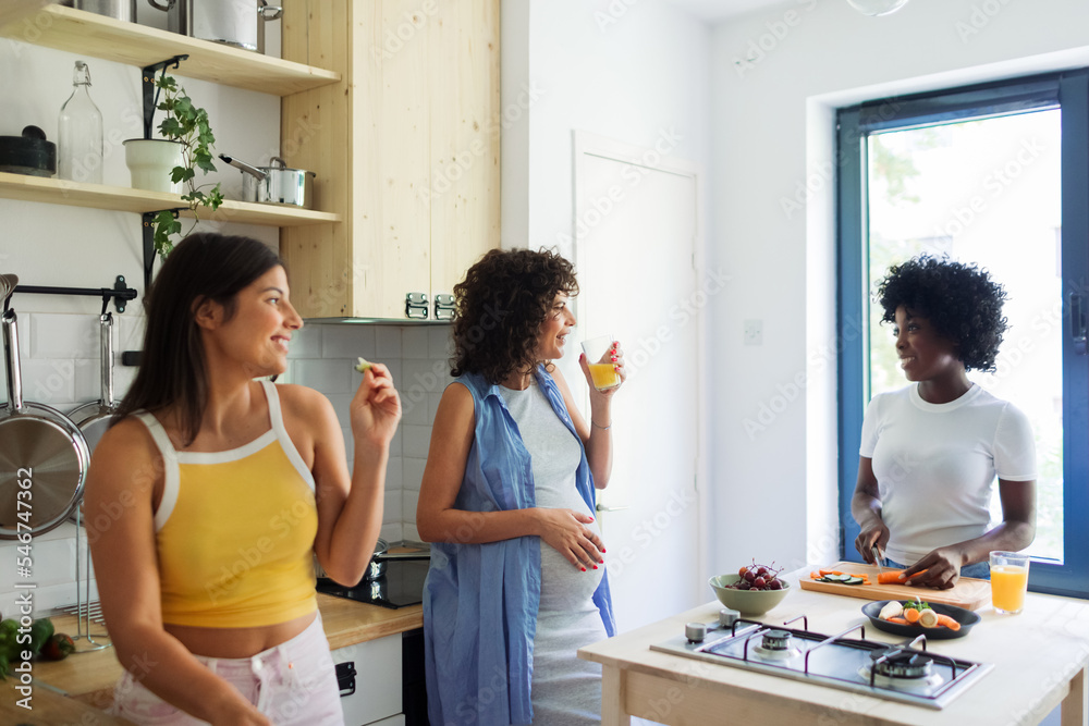 Women Hanging Out in Kitchen Stock Photo | Adobe Stock