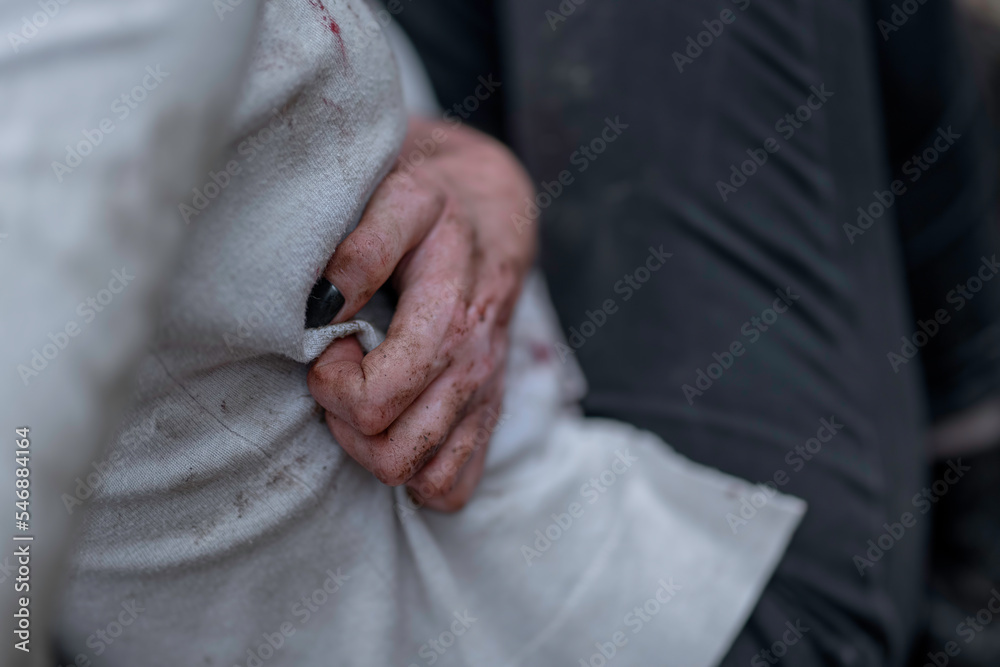 Hand clamps a bloody wound on the side Stock Photo | Adobe Stock