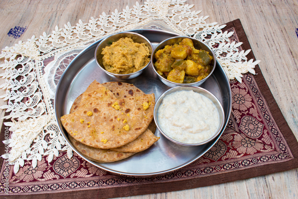 Fotografie Dal Puri or dal stuffed paratha in plate and Gur kheer ...