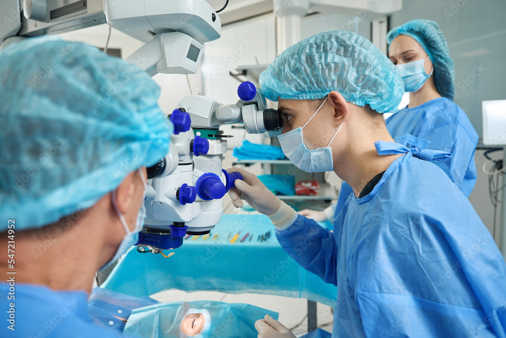 Surgeons doing a laser vision correction operation Stock Photo | Adobe ...