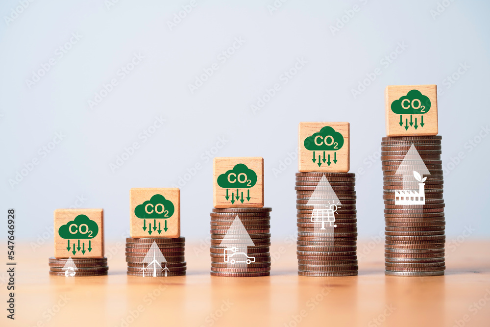 Increasing coins stacking with up arrow and CO2 reducing icon for decrease CO2 , carbon ...