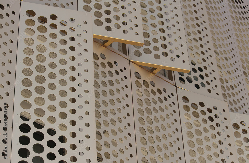 Gold perforated cladding on the outside of a building Stock Photo ...
