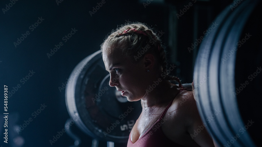 A Confident Female Powerlifter Training and Working out with Heavy ...