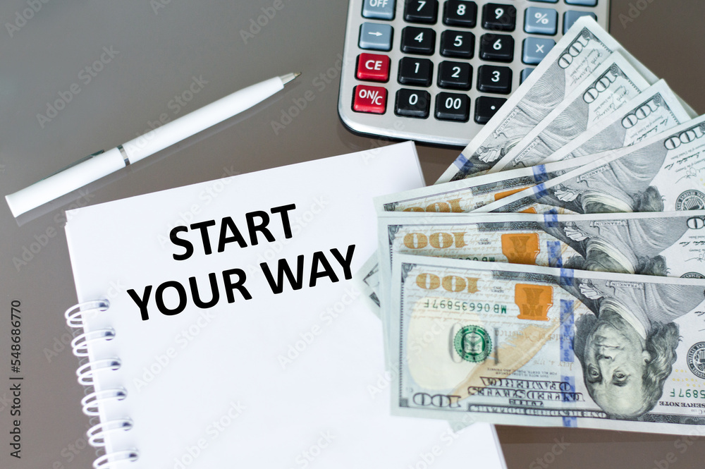 Start Your Way text on a notepad next to a pen, calculator and dollar ...