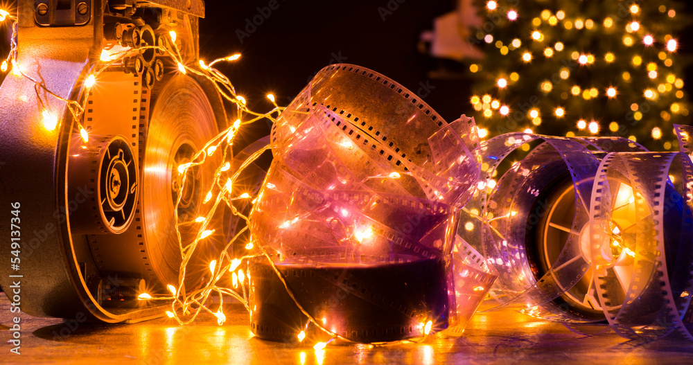 christmas background with film strip and movie camera cassette against ...