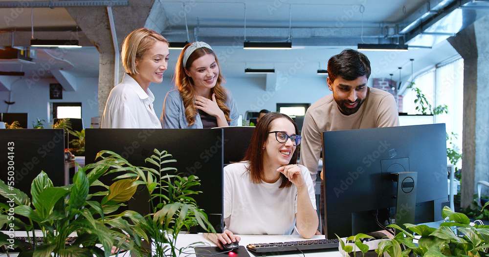 Office workers talking at computer and watching at screen. Male ad ...