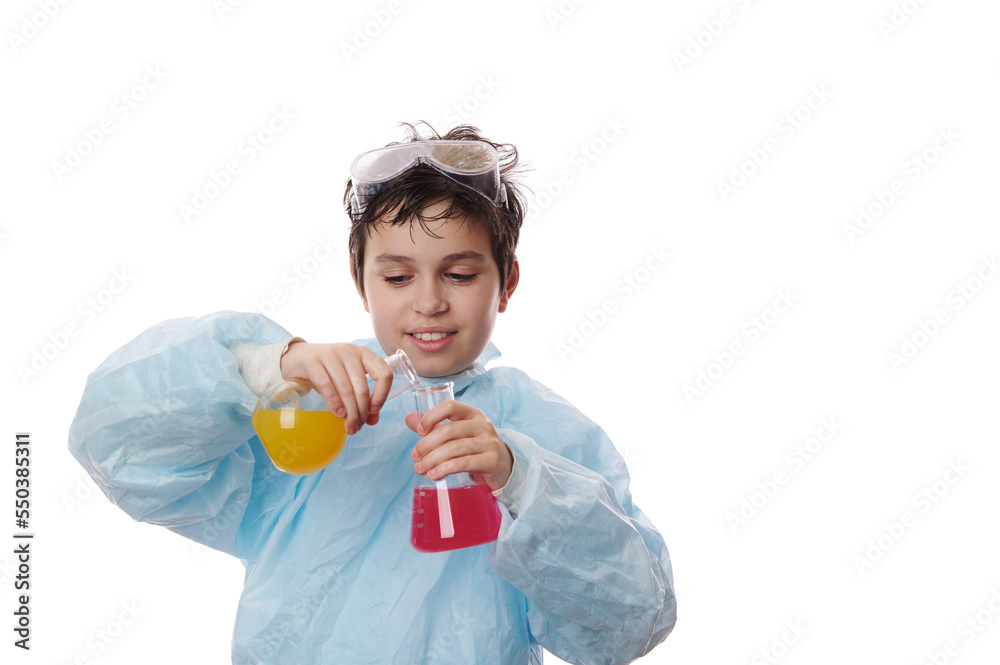 Close-up schoolboy at chemistry class, pouring solution from a glass ...
