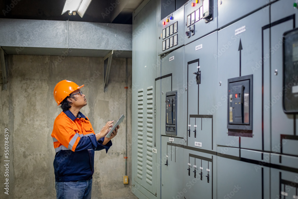 The engineer checking and inspecting at MDB panel .he working with ...