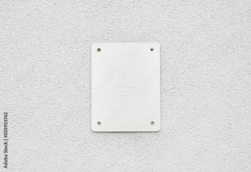 Ground cable cover plate, symbol on the side wall of a building, sign ...