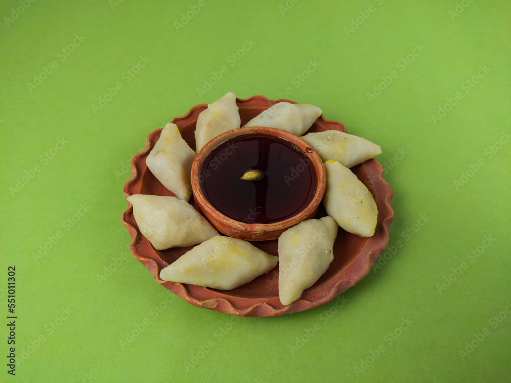 puli pithe or bengali rice flour dumplings with coconut fillings served ...