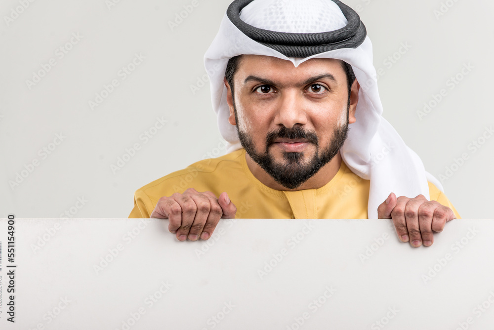Handsome arab man wearing traditional emirate clothing portrait in ...