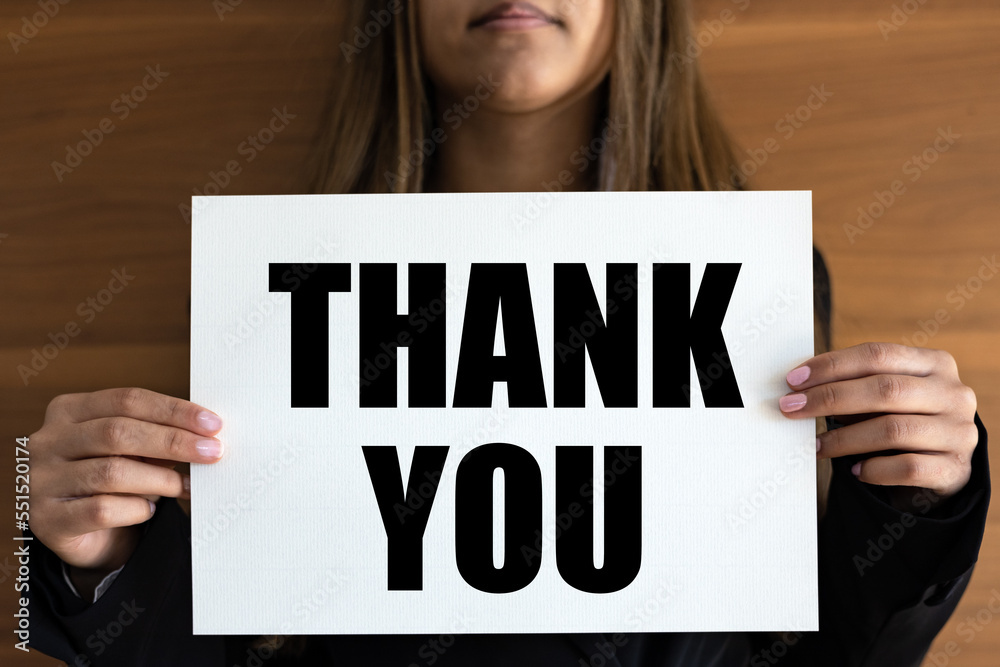 Thank you. Woman holds a white page with orange text. Gratitude ...