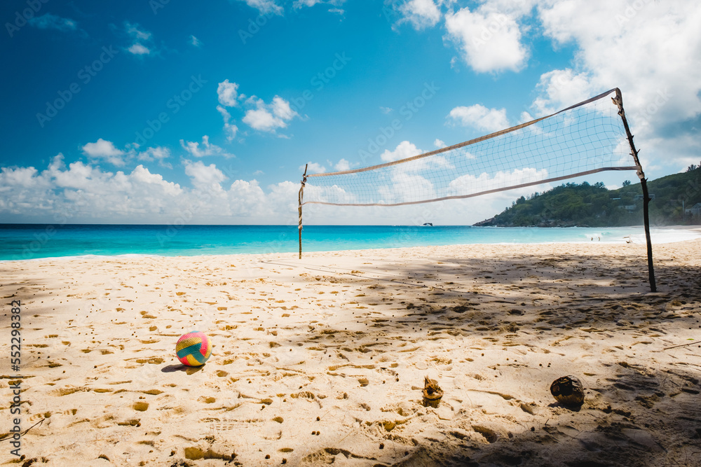 Volleyball net on tropical beach with blue sky. Beach volleyball court ...