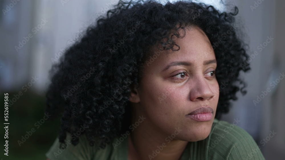 One contemplative young black woman closeup face. Pensive Brazilian ...