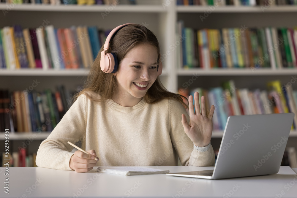 Happy cheerful gen Z high school student girl in headphones enjoying ...