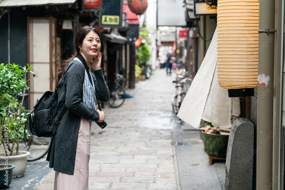 smiling taiwanese woman photographer looking into distance admiring the ...