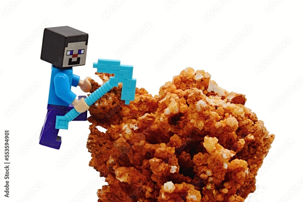 LEGO Minecraft figure of Steve with diamond pickaxe trying to mine real ...