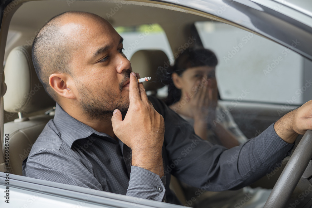 Husband smoking cigarette and wife choking of smoke. Man smoking ...