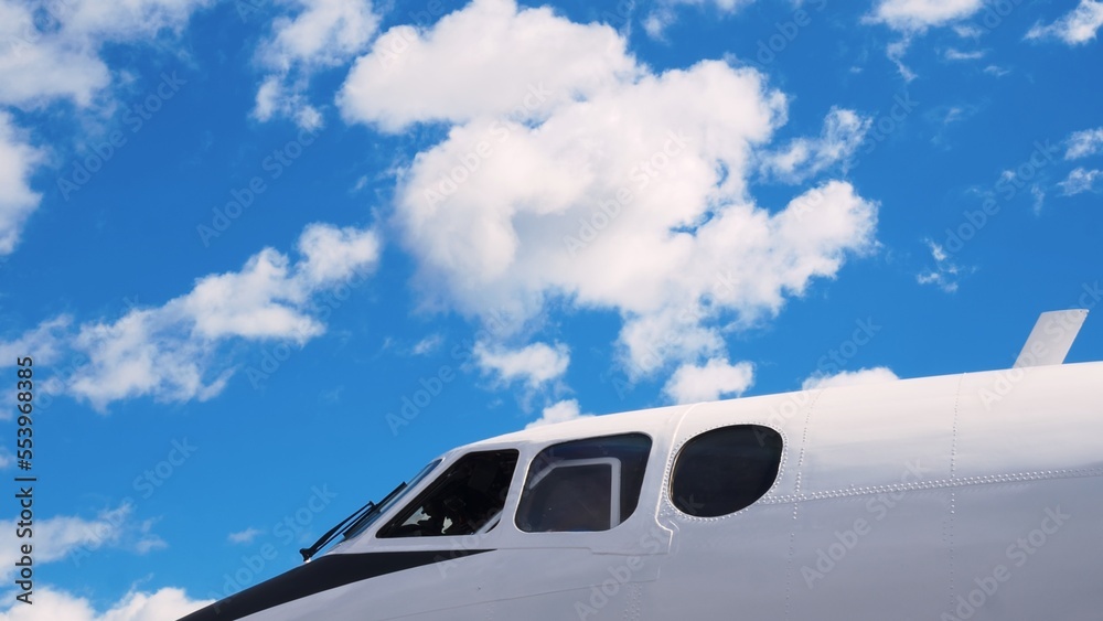 Fotografie Side view of the nose of a white aircraft with dark windows ...