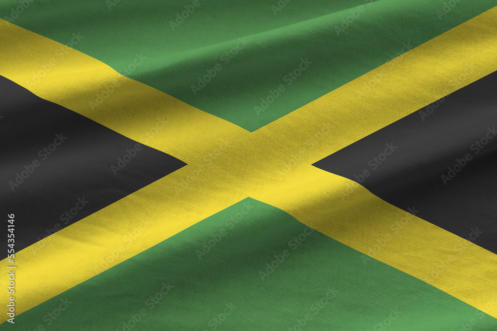 Jamaica flag with big folds waving close up under the studio light ...