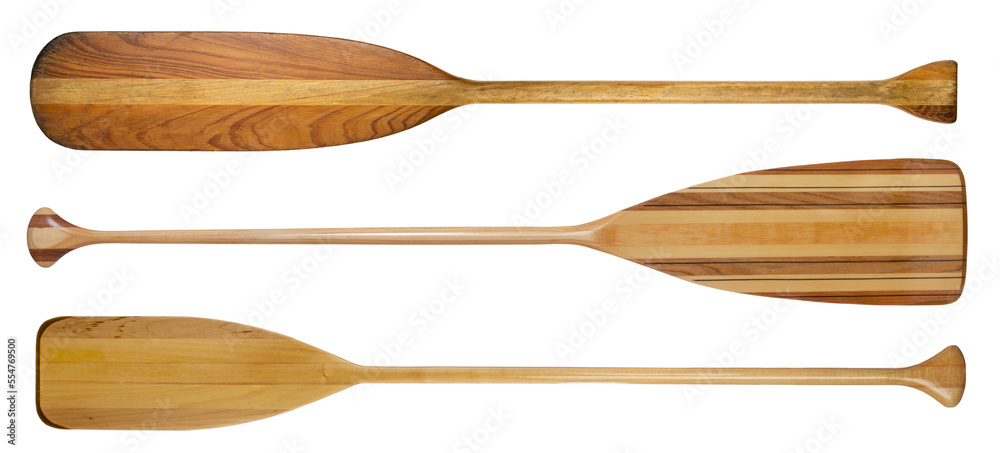 three traditional wooden canoe paddles with different shape of blades ...