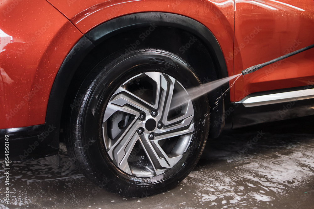 Washing red luxury car in detailing service. Close up image of the ...