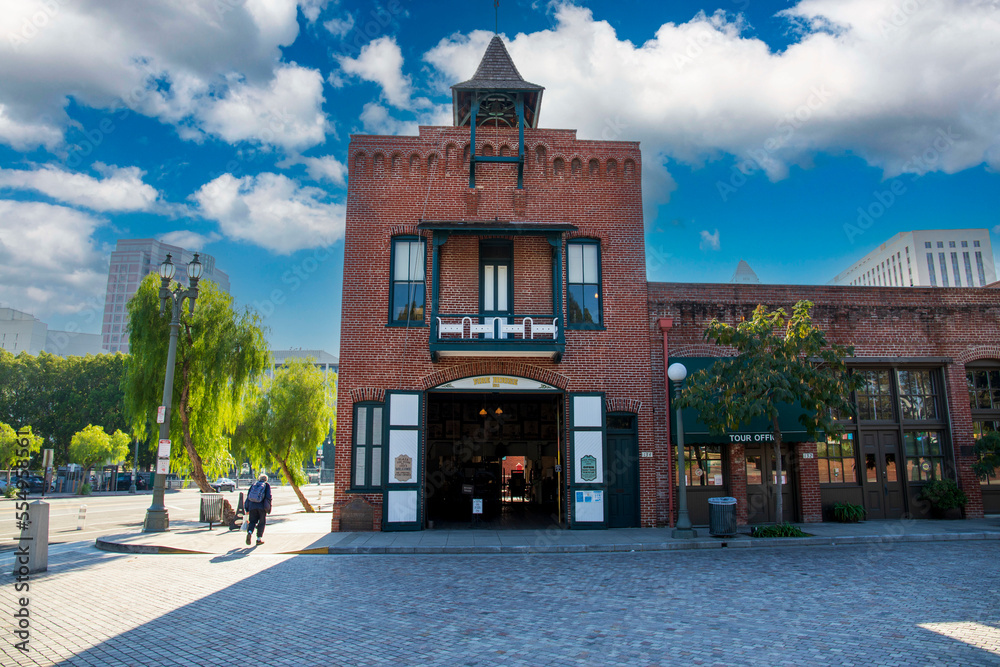 the red brick Plaza Firehouse surrounded by lush green trees at El ...