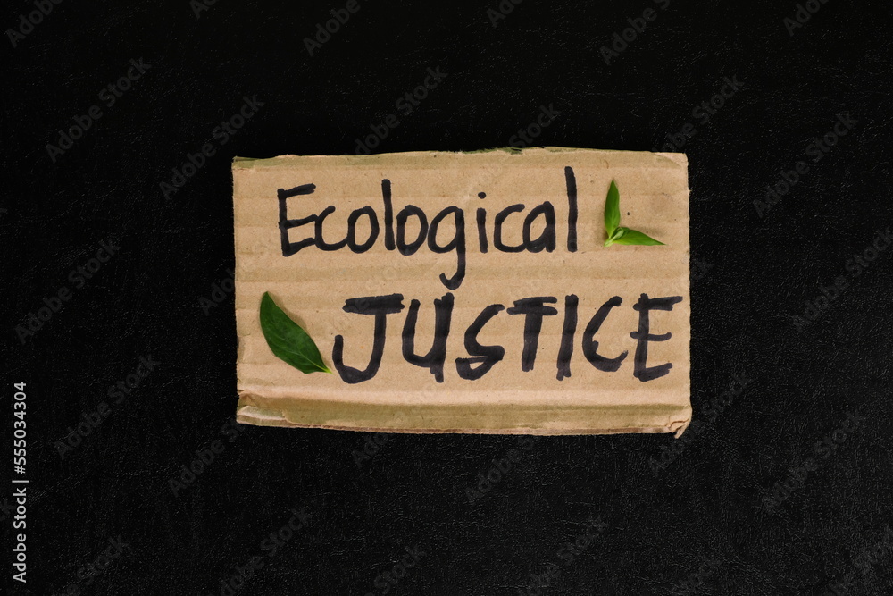 Ecological justice concept. Carton placard with handwritten message in ...