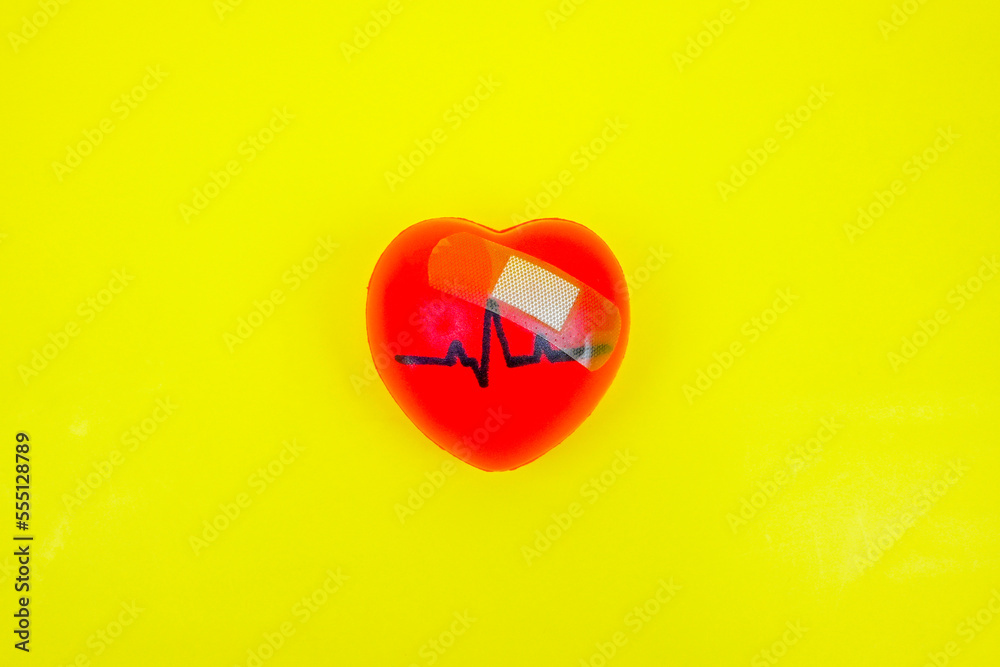 Pulsing heart, heartbeat with Band-Aid symbolise as heart diseases ...