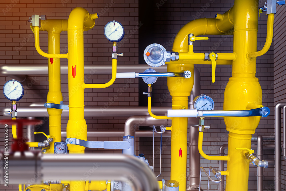 Yellow pipes in basement. Gas industry. Pipes with pressure meters. Gas ...
