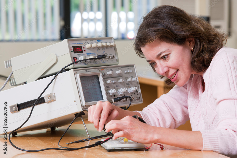 Engineering student making connections on circuit breadboard for ...
