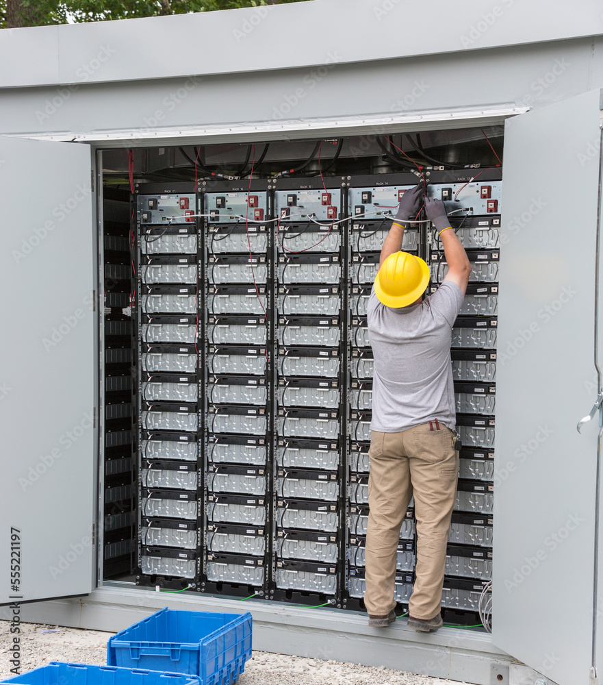 Foto de Stock Engineer connecting energy storage batteries for back up ...