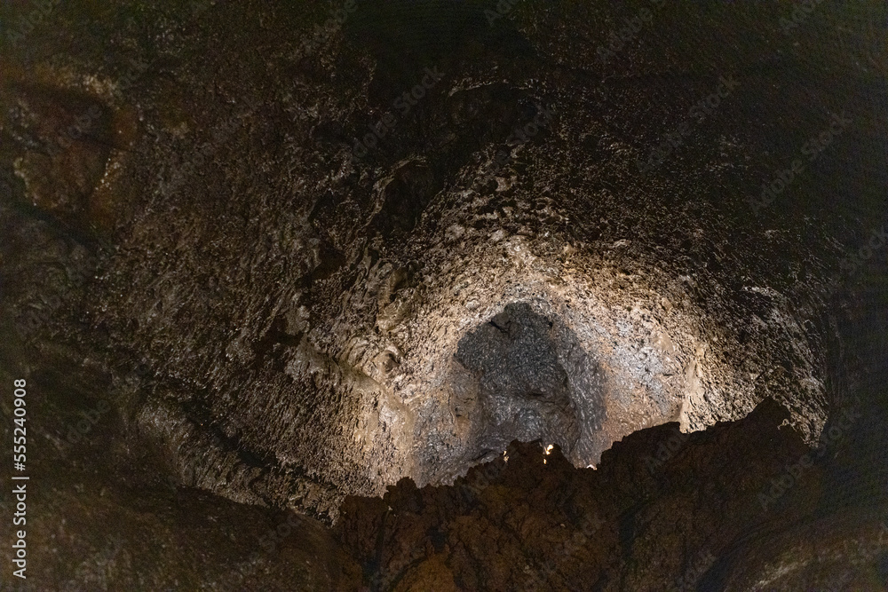 Exploring a volcanic cave in the Volcanic Caves Park at the foot of ...