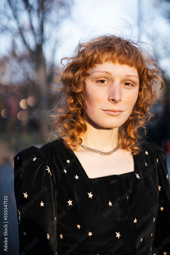 portrait of woman with red hair and freckles in urban park Stock Photo ...