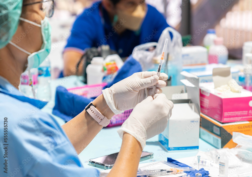 Nurse drawing up solution and filling syringe. Stock Photo | Adobe Stock