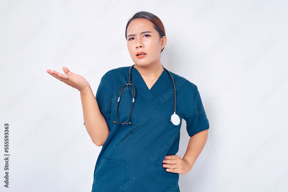 Confused young Asian woman nurse wearing blue uniform with a ...
