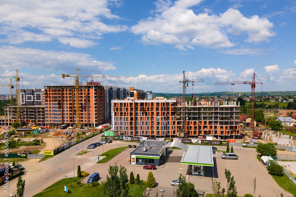 Tower crane at high concrete residential building under construction ...