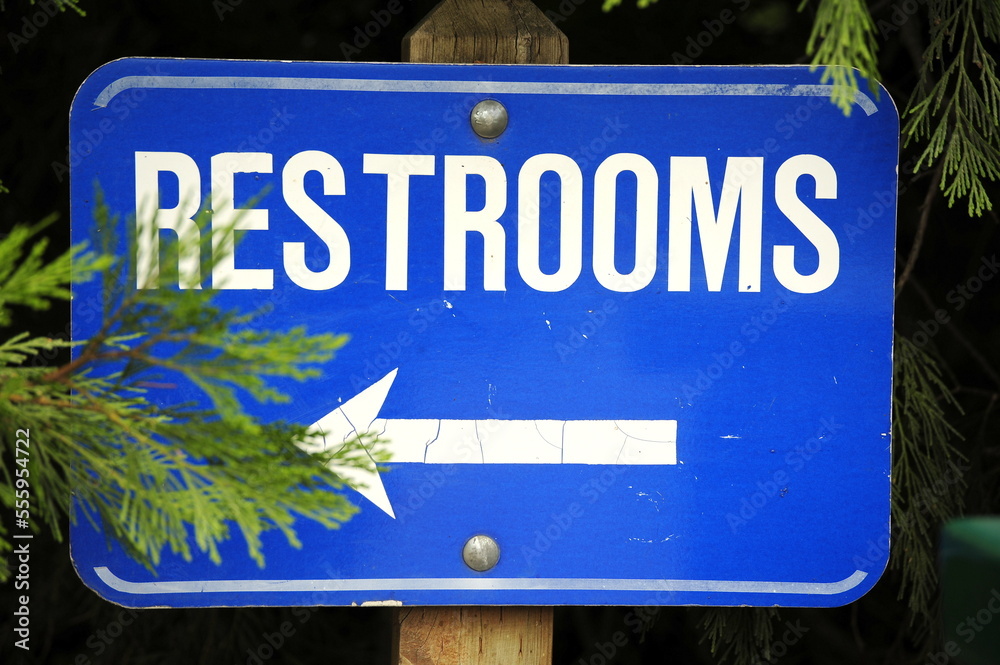 Restroom sign displayed outdoors. Stock Photo | Adobe Stock