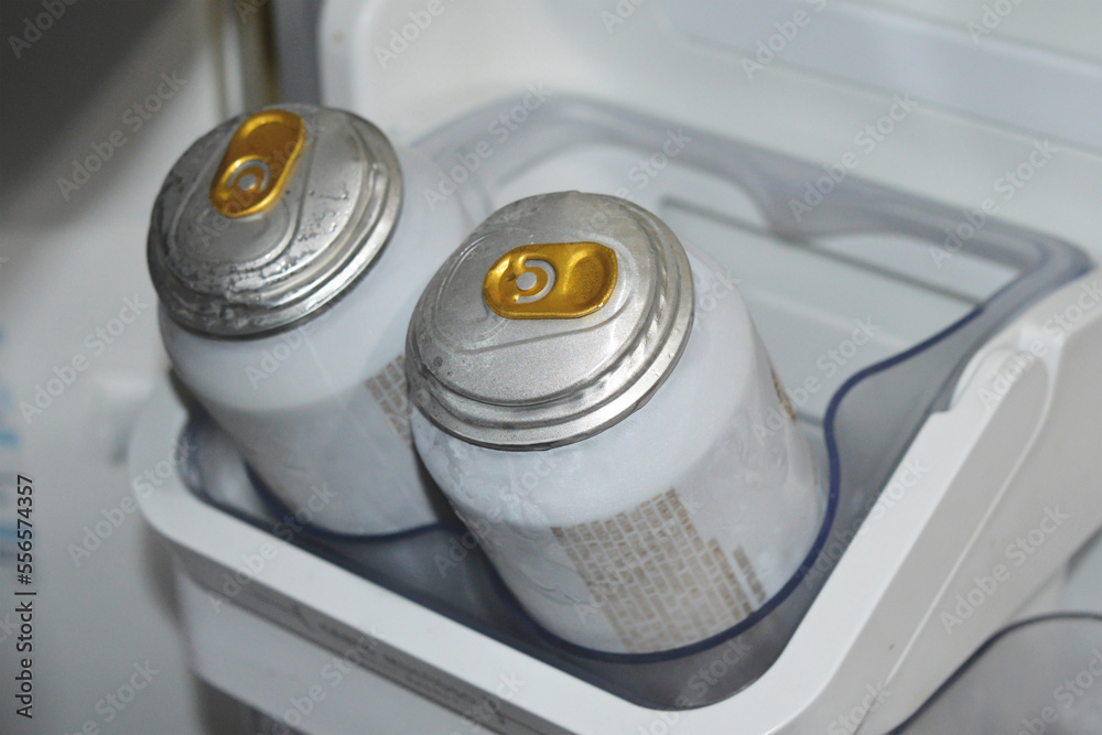 Two beer cans damaged and with bumps on the top because of too low ...