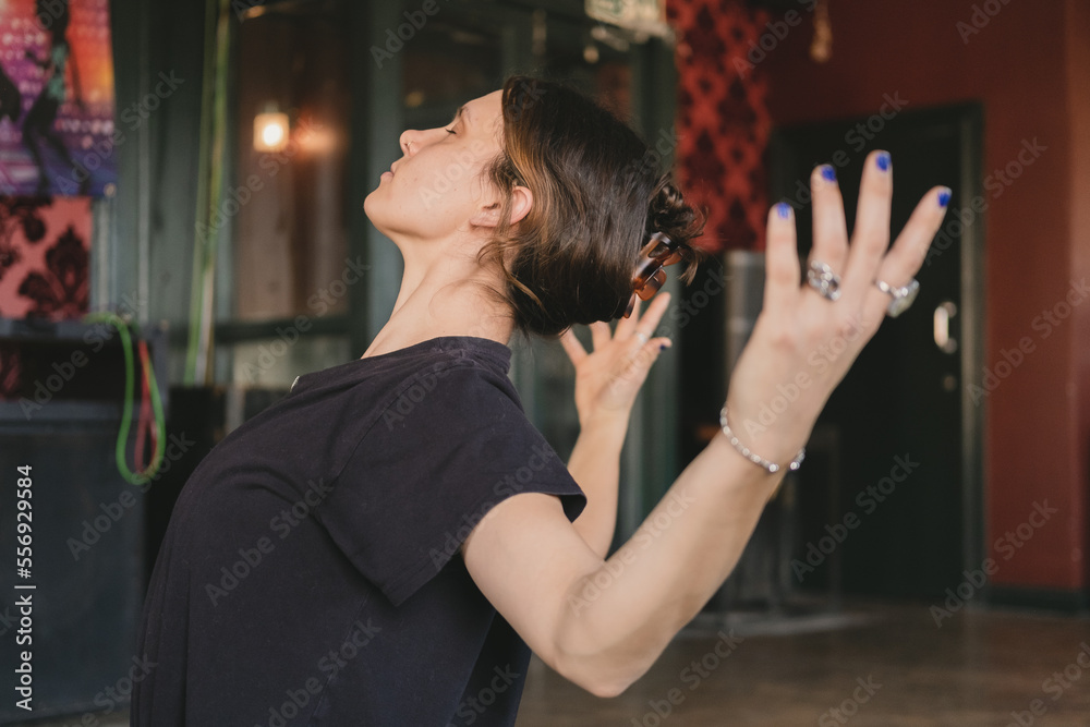 Sideways photo of a female new yoga teacher in a backbend pose with ...