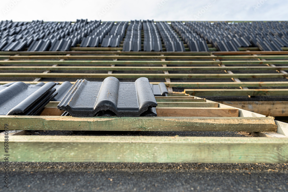 Roof ceramic tile arranged in packets on the roof on roof battens ...