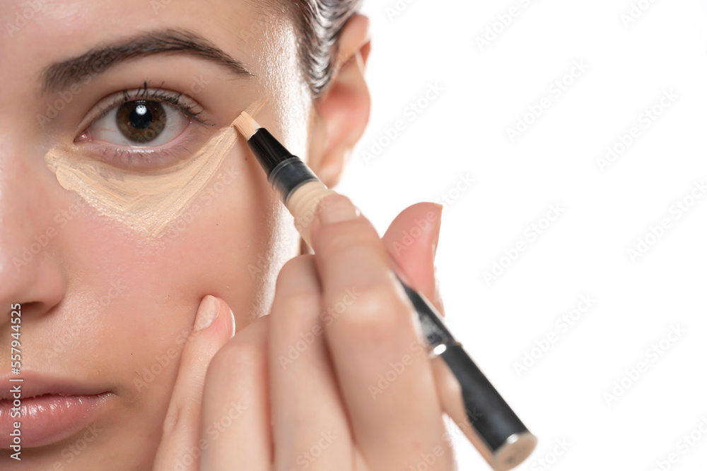 Woman applying concealer on flawless fresh skin, doing make up. Girl ...