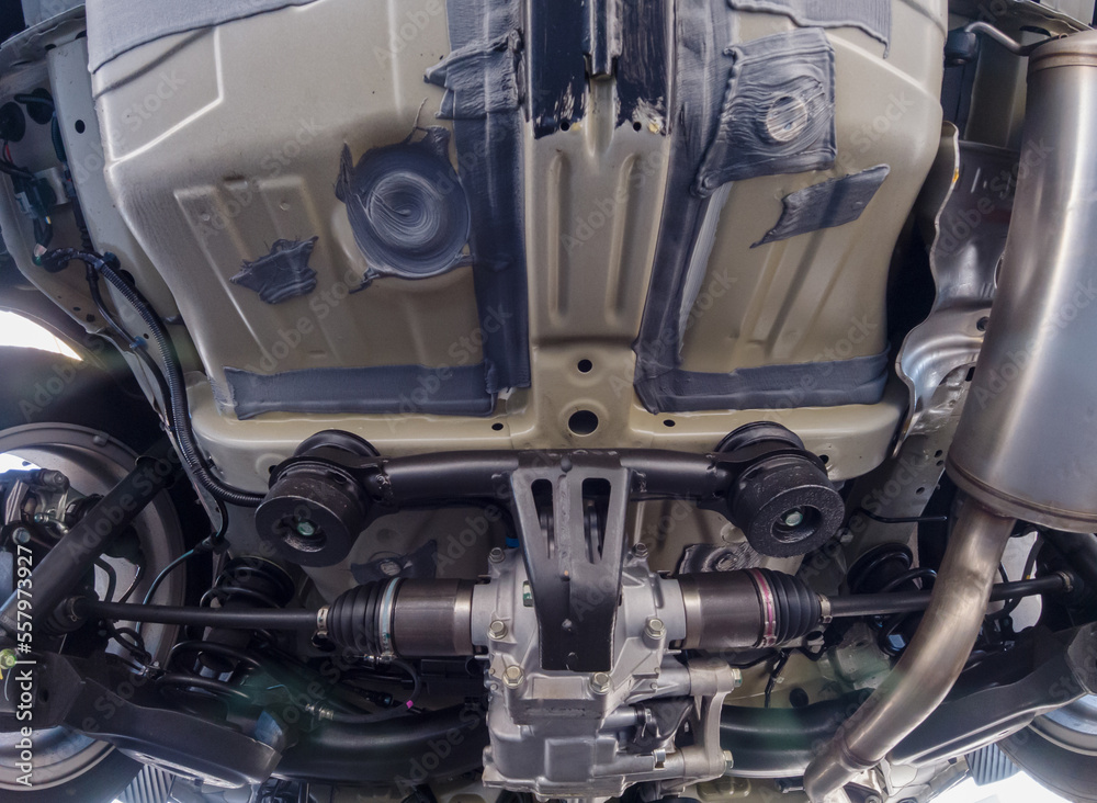 Auto mechanic view of bottom of the car. Rear differential axle wide ...