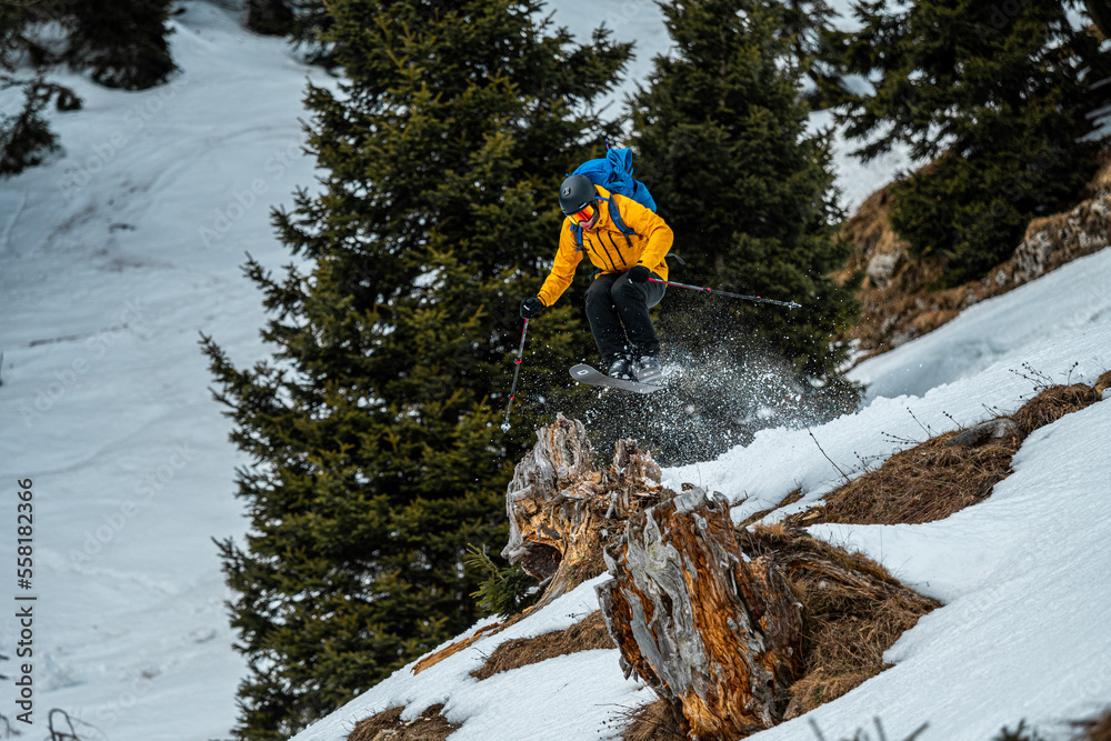 Freeride skier jumping over tree stumps Stock Photo | Adobe Stock